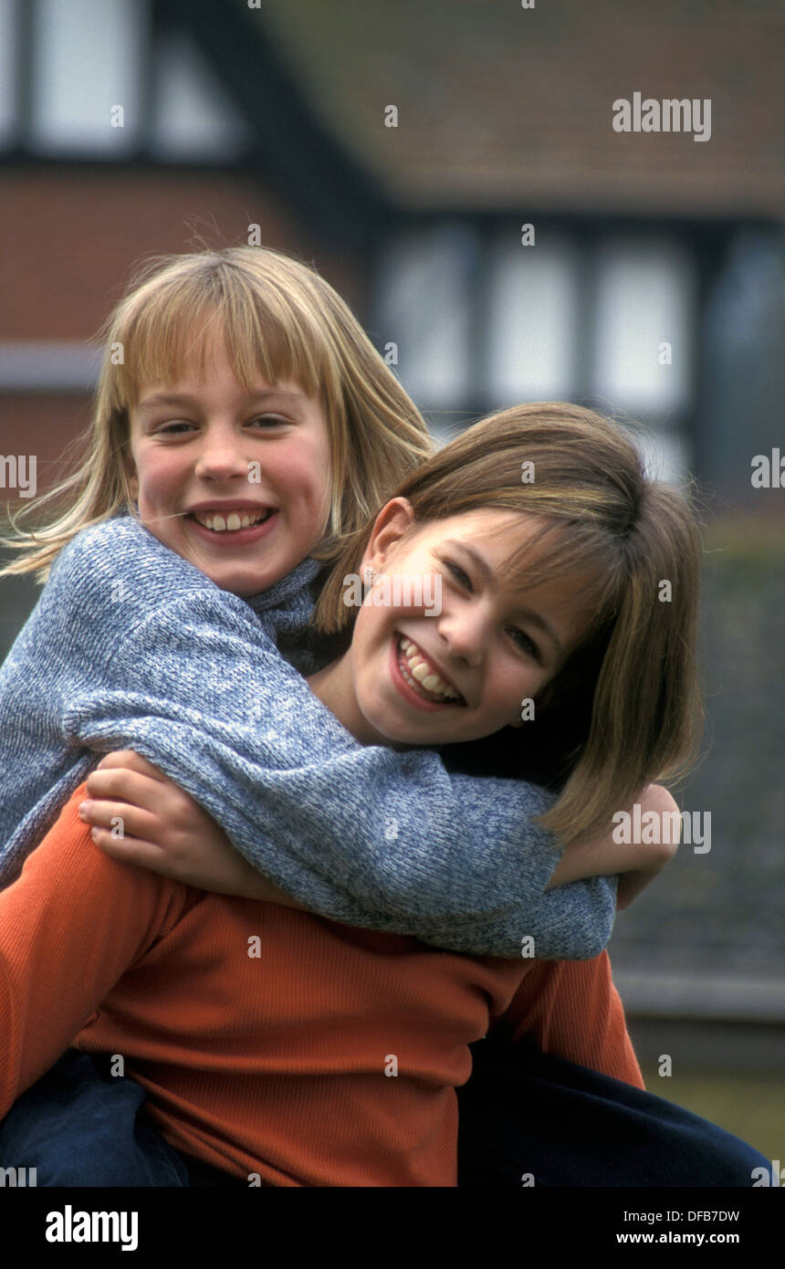 two happy girls having piggyback Stock Photo - Alamy
