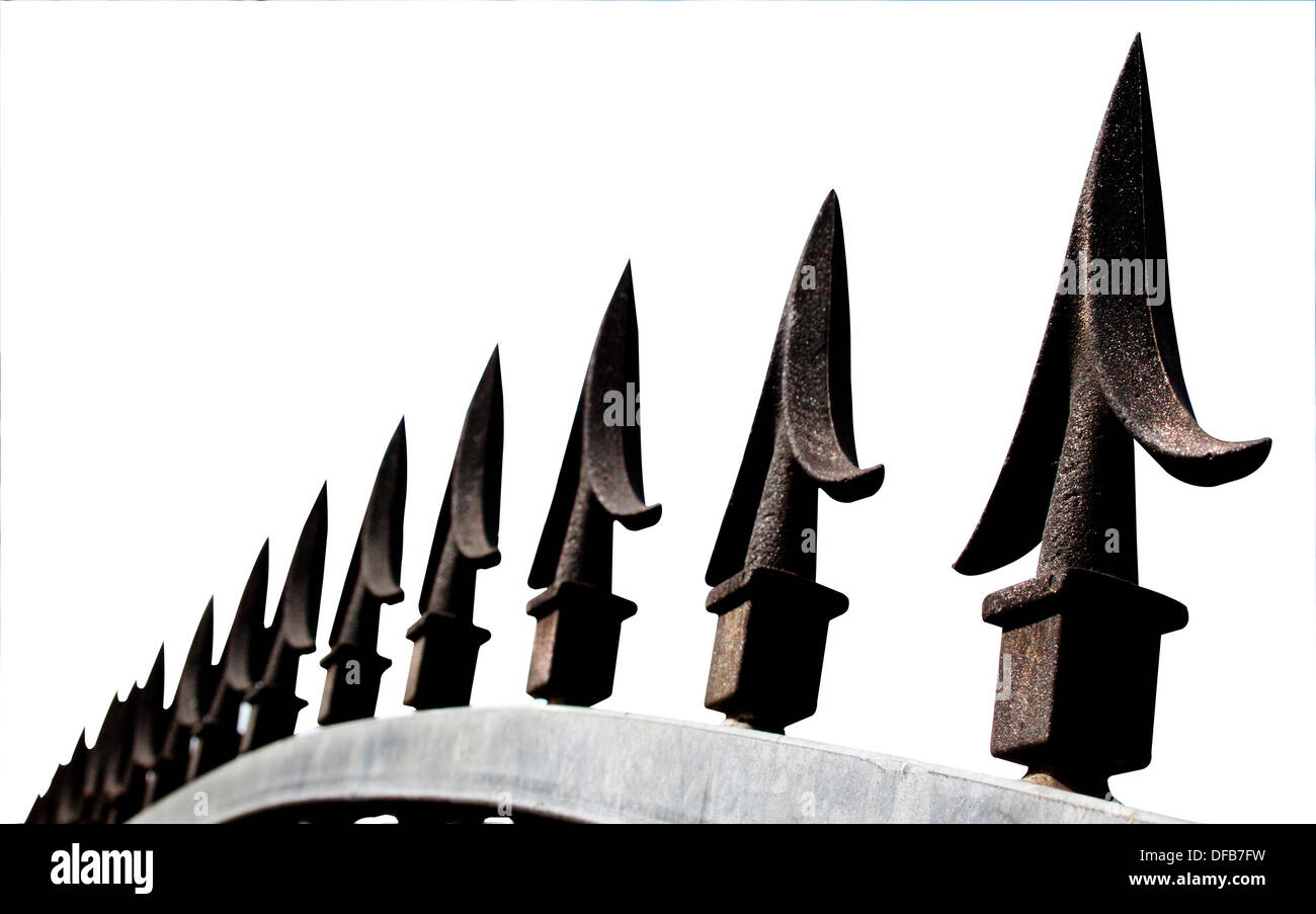 An extreme closeup of decorative black spikes on top of galvanized ...