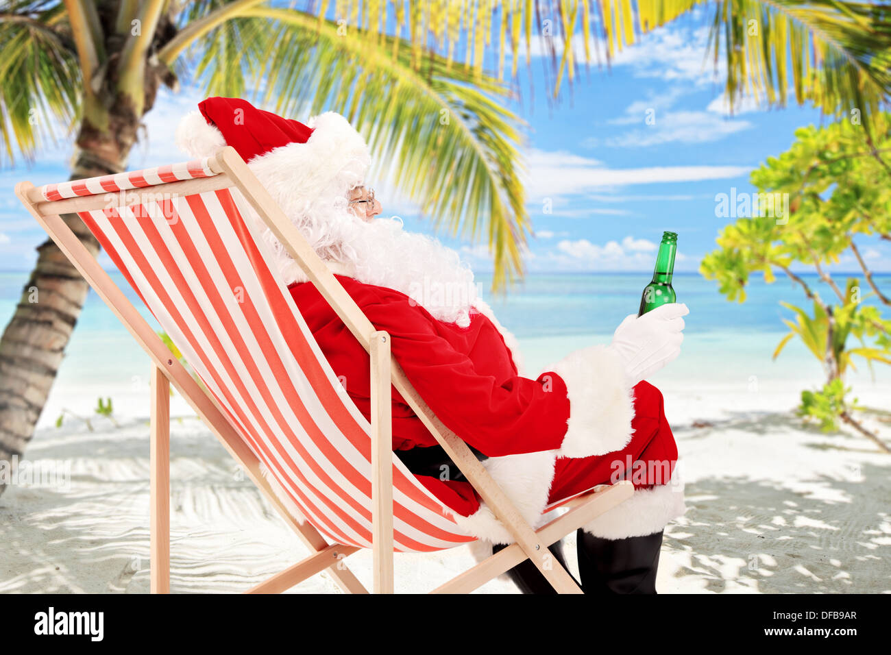 Santa Claus on a beach chair drinking beer and enjoying on a sunny day ...