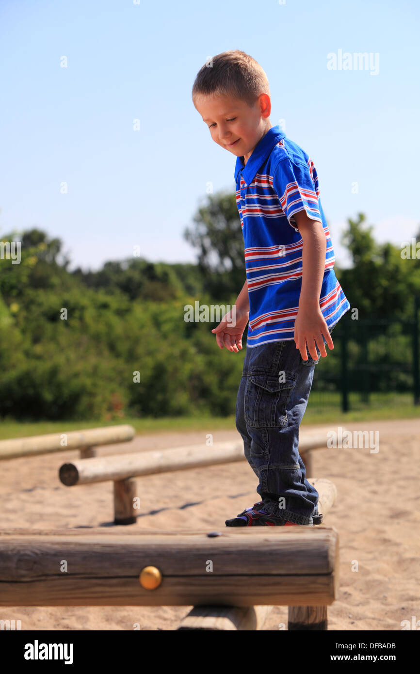 child in playground kid in action boy play on leisure equipment Stock ...