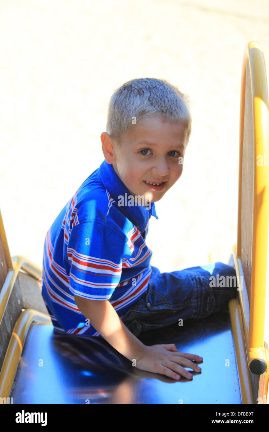 child in playground kid in action boy play on leisure equipment ready ...