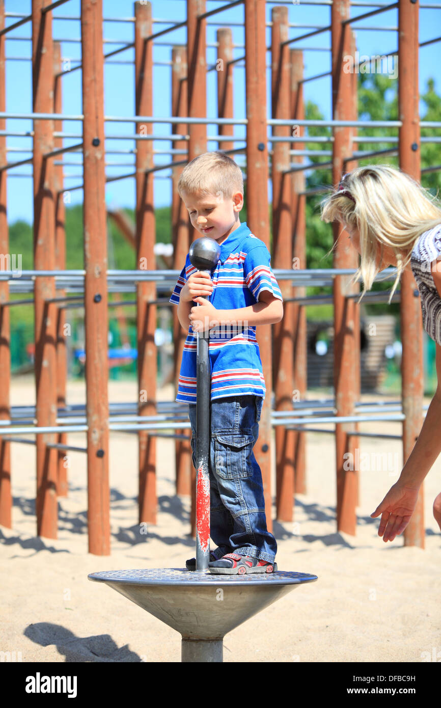 young child boy or kid playing in playground on leisure equipment Stock ...