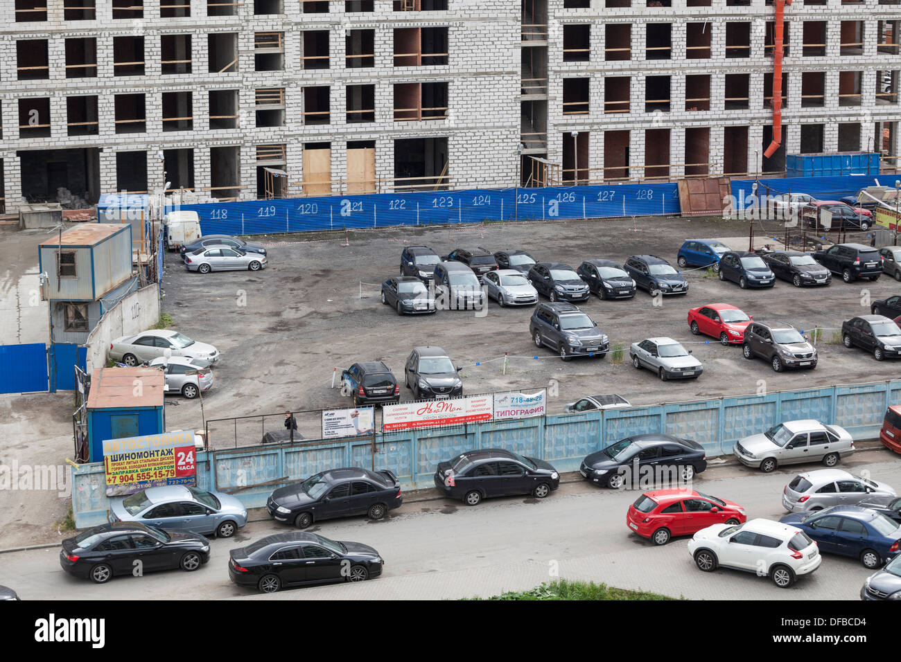 Cars parking place near building under construction on Constitution ...