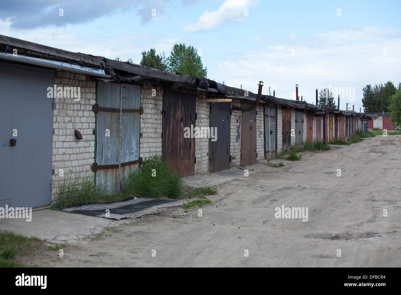 Line from brick garages with an iron gates in Russian province town ...