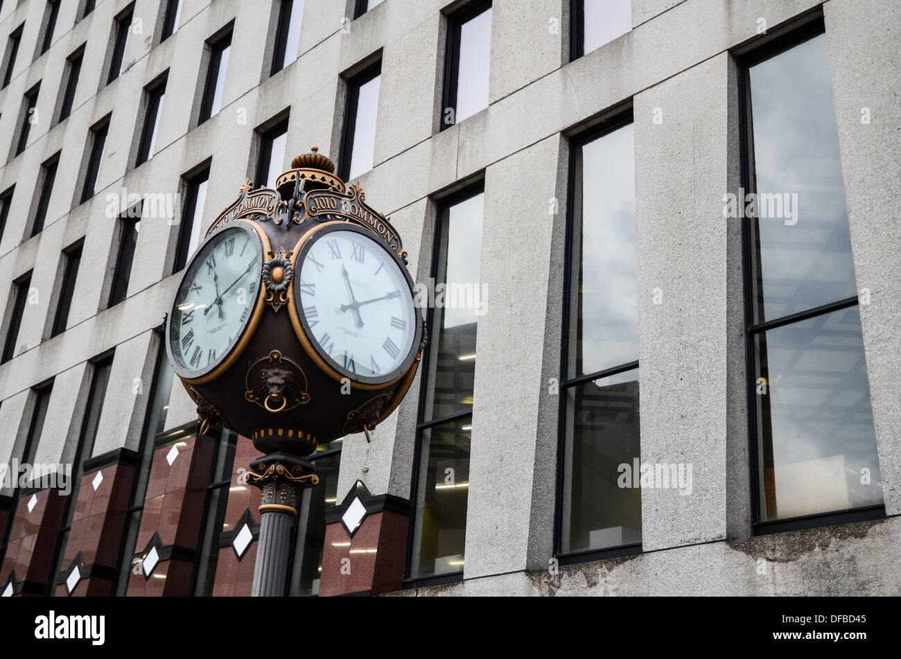 Street outside clocks near skyscraper Stock Photo - Alamy