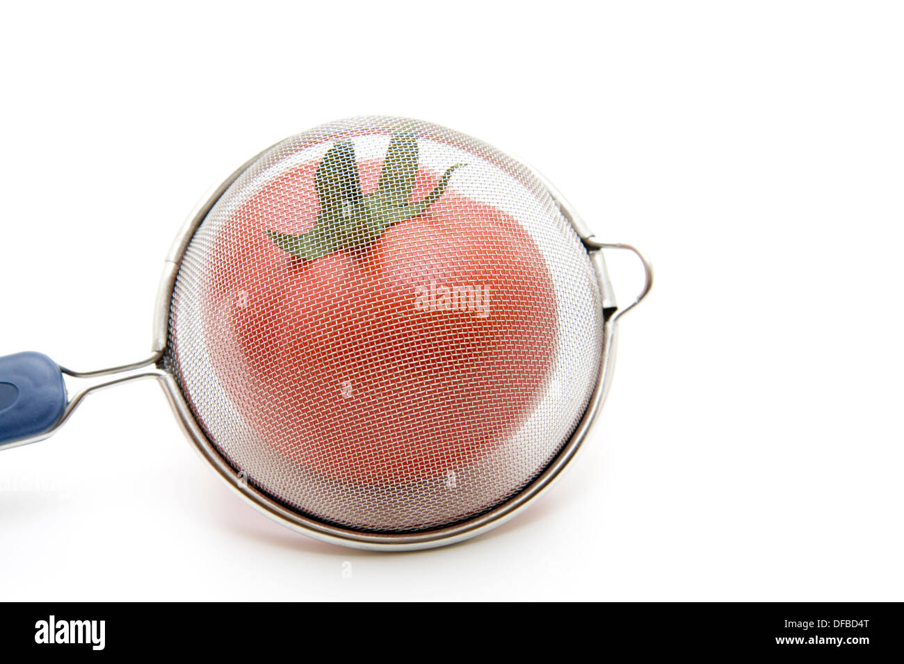 Kitchen sieve with tomato Stock Photo - Alamy