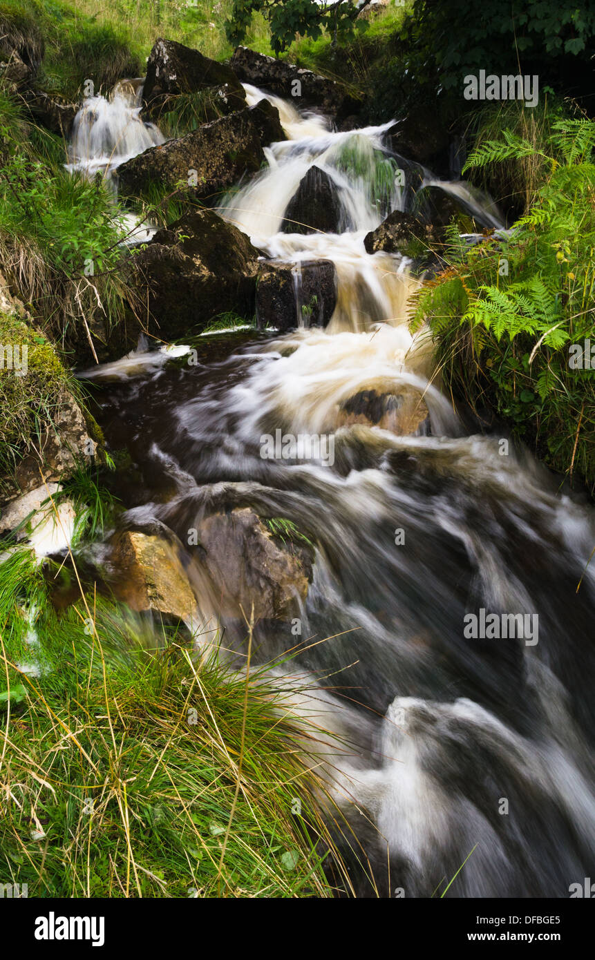 Flowing water in a gentle waterfall Stock Photo - Alamy
