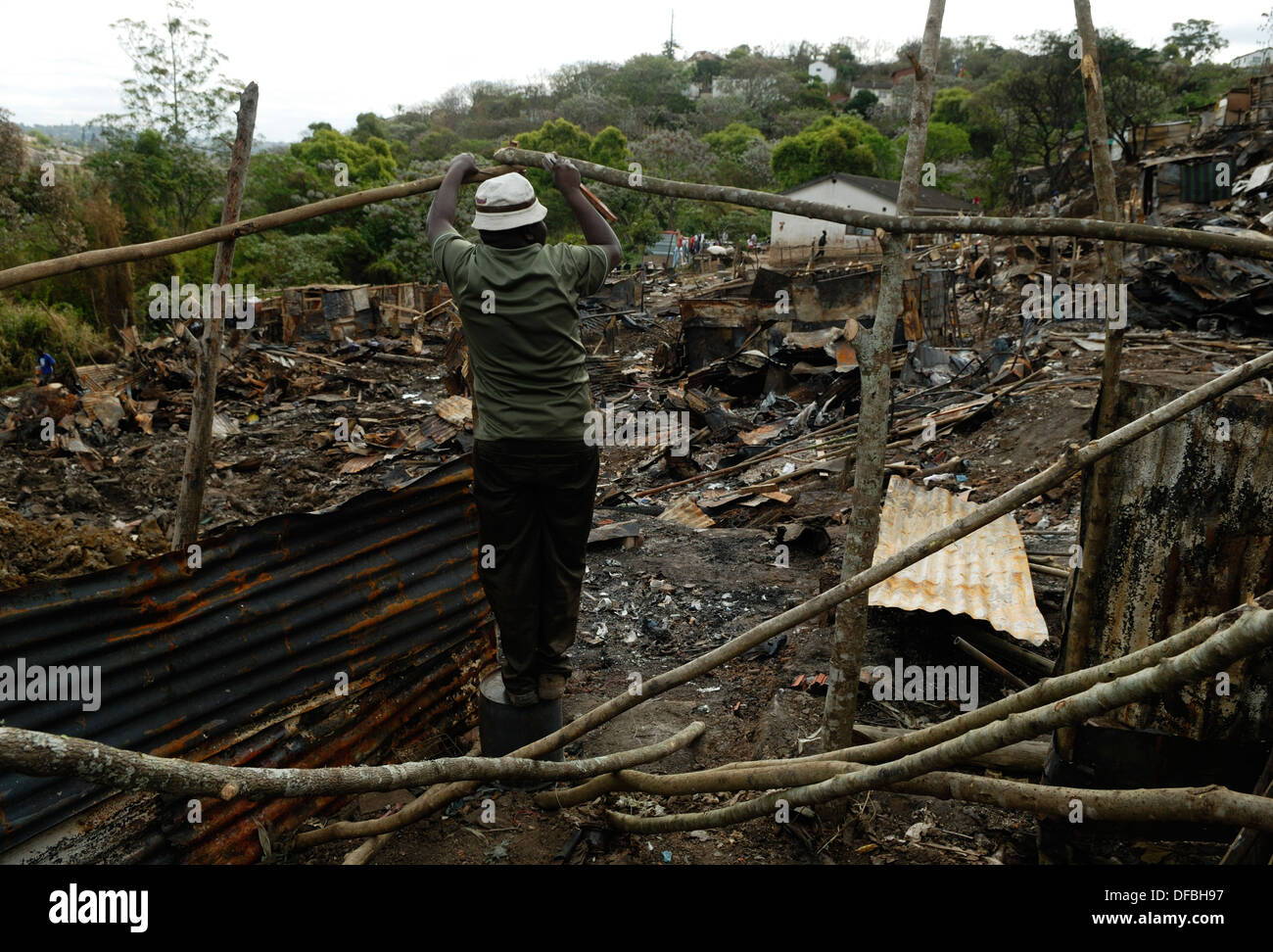 A man rebuilds his shack which was destroyed by fire in Foreman Road ...