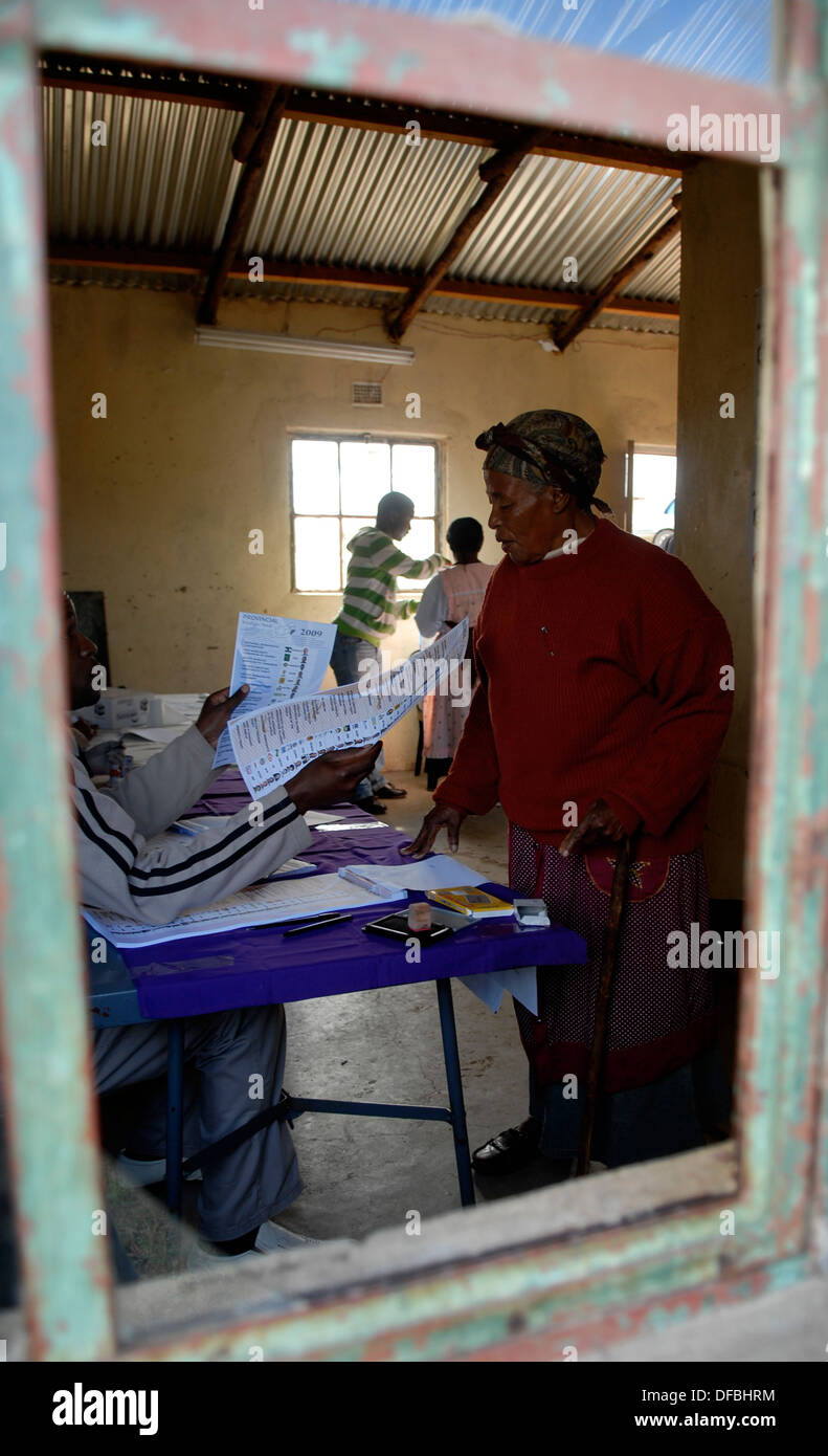 A South African voter is seen collecting her ballot papers a rural ...