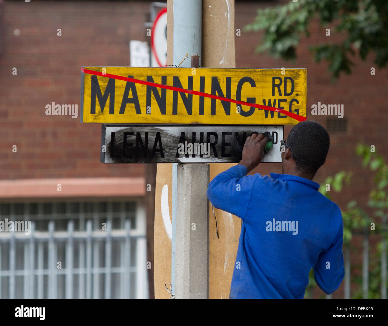 A worker cleans a Durban street sign which was defaced by protesters ...