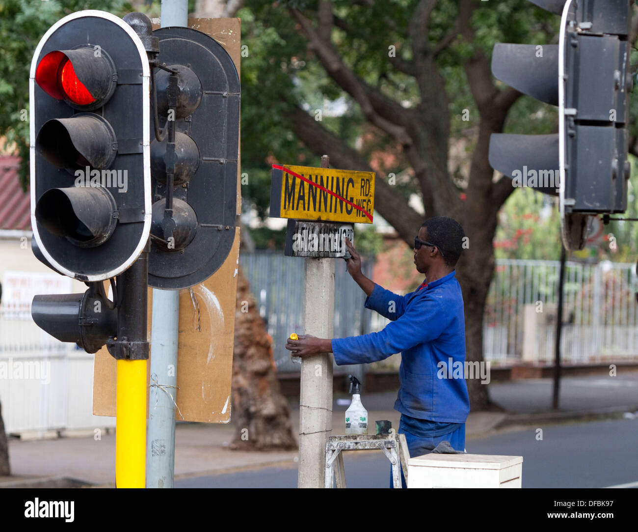 A worker cleans a Durban street sign which was defaced by protesters ...
