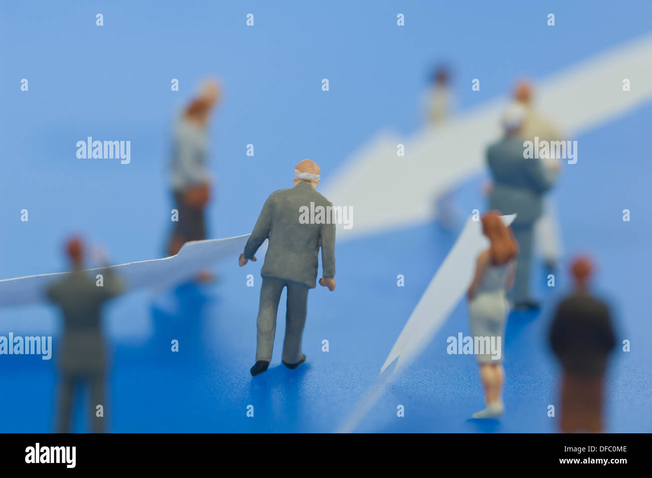 Senior figurine of pensioners with arrow sign Stock Photo - Alamy