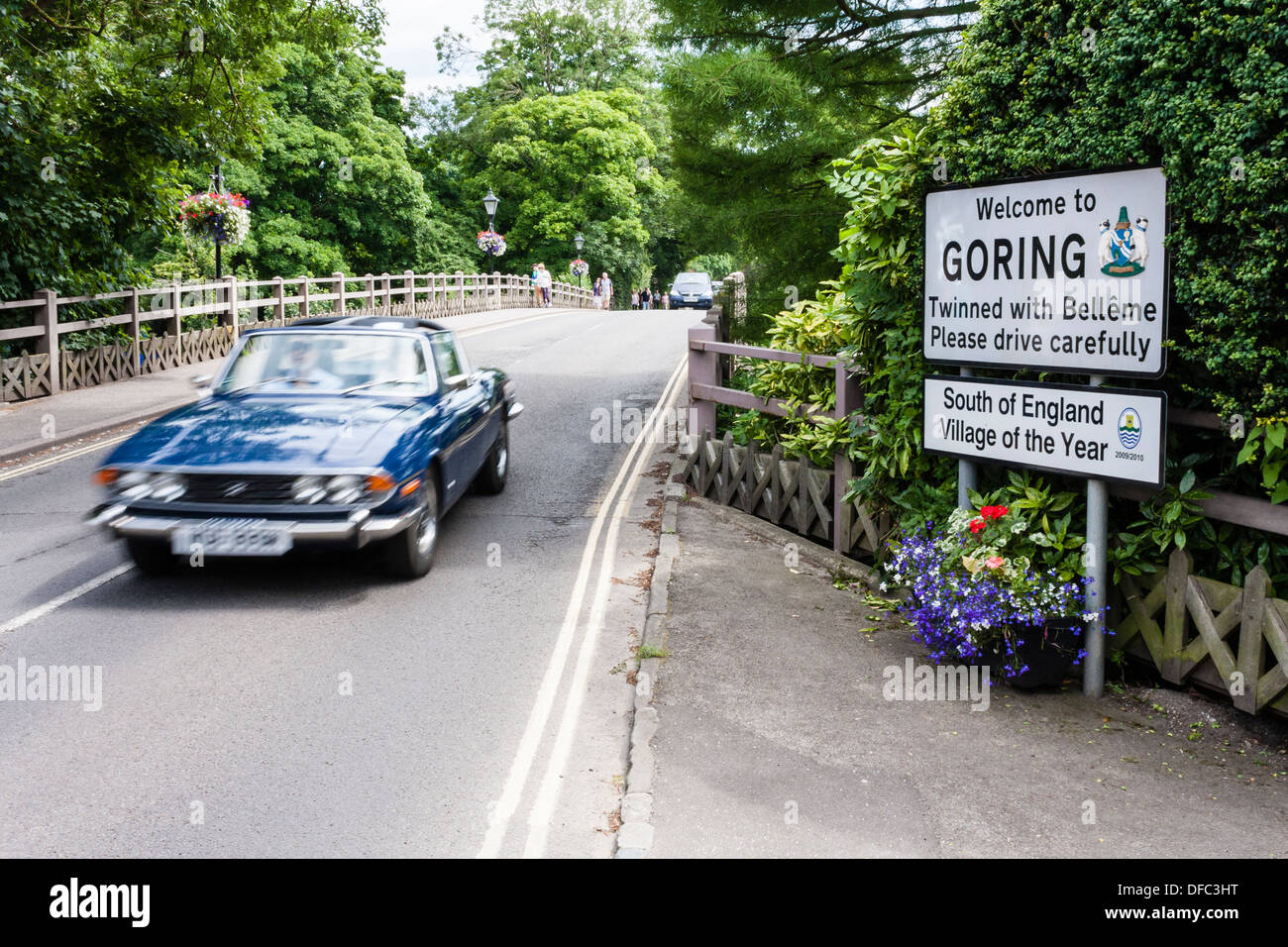 Sports car drives over Goring bridge past welcome sign, Goring-on ...