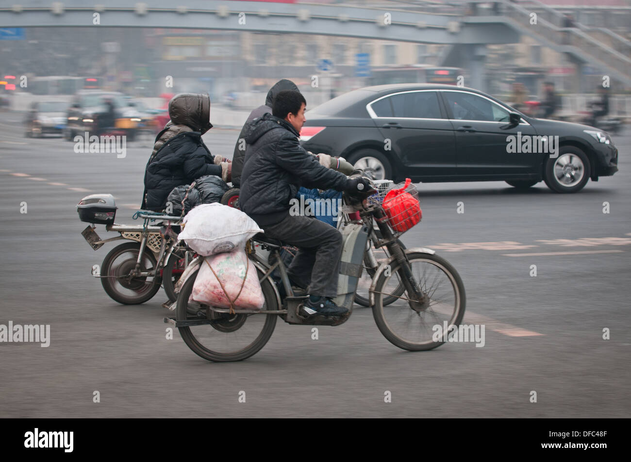 Chinese men on moped and scooter in Beijing, China Stock Photo - Alamy