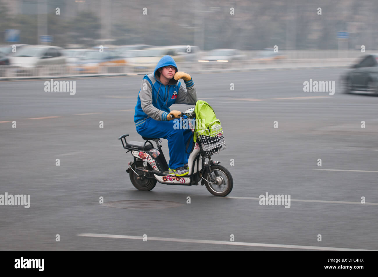 Young Chinese on moped in Beijing, China Stock Photo - Alamy