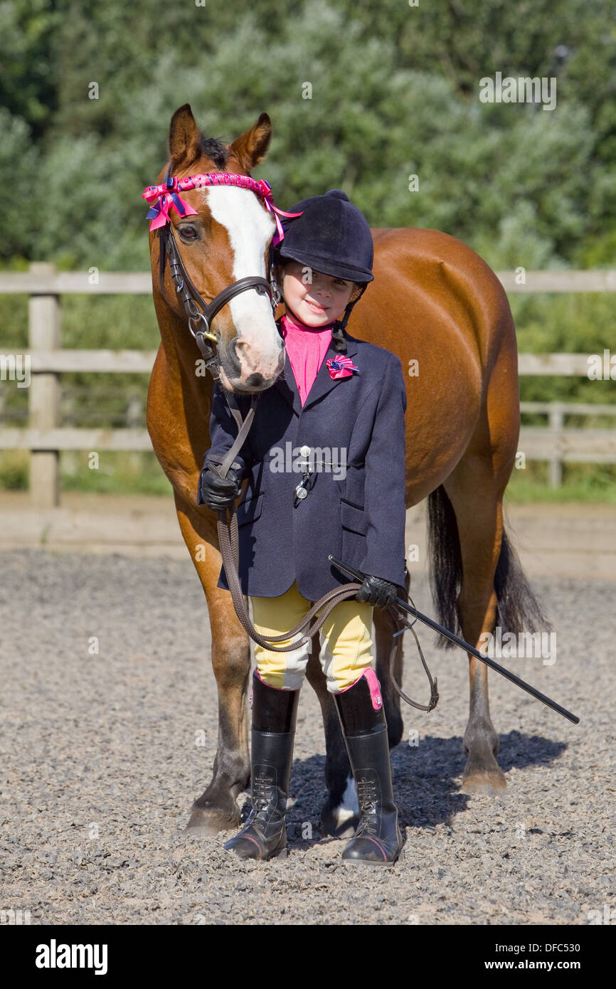 A competitor with their horse at an outdoor equestrian competition ...