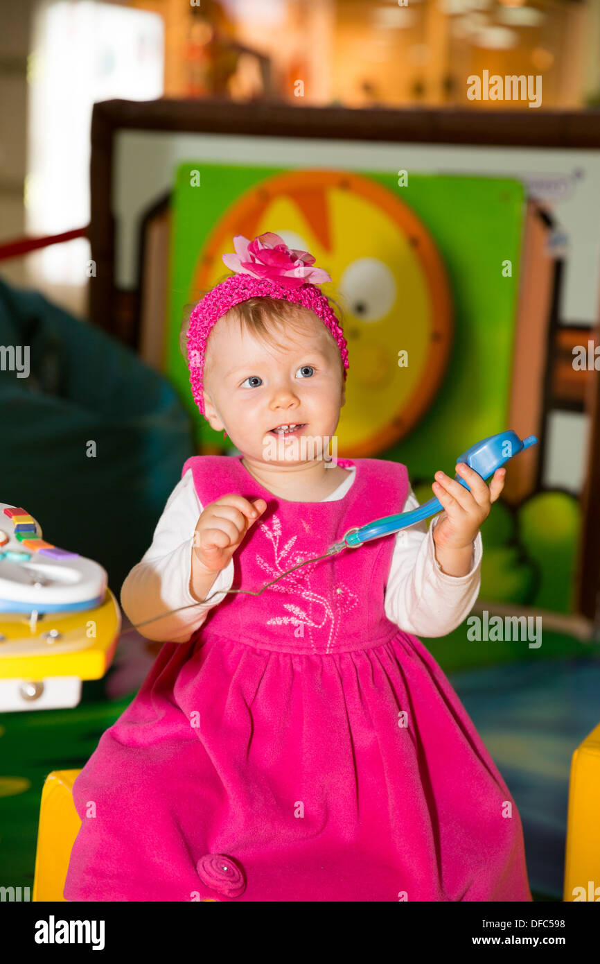 Happy child girl talking on the phone on playground The concept of ...