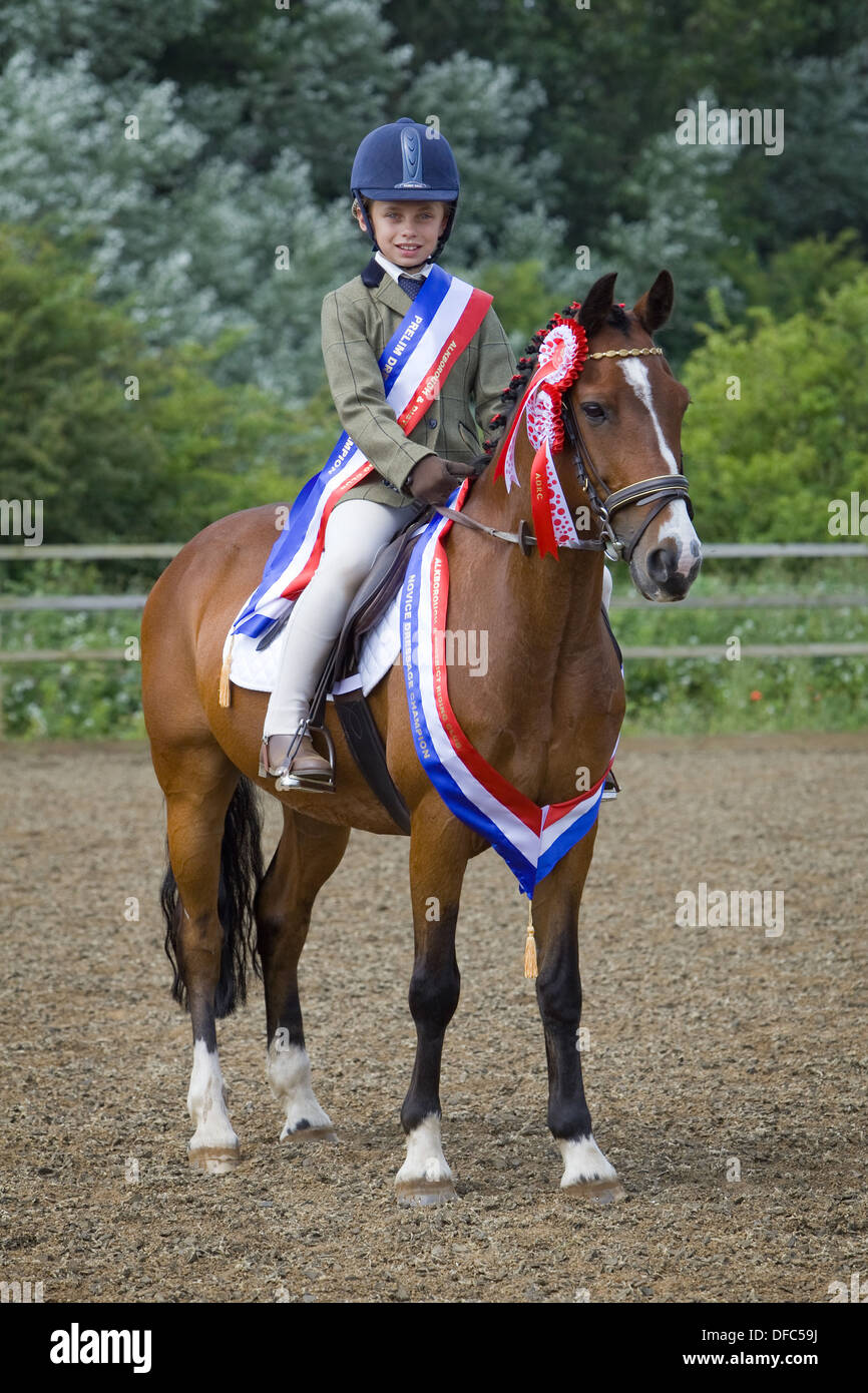 A competitor with their horse at an outdoor equestrian competition ...