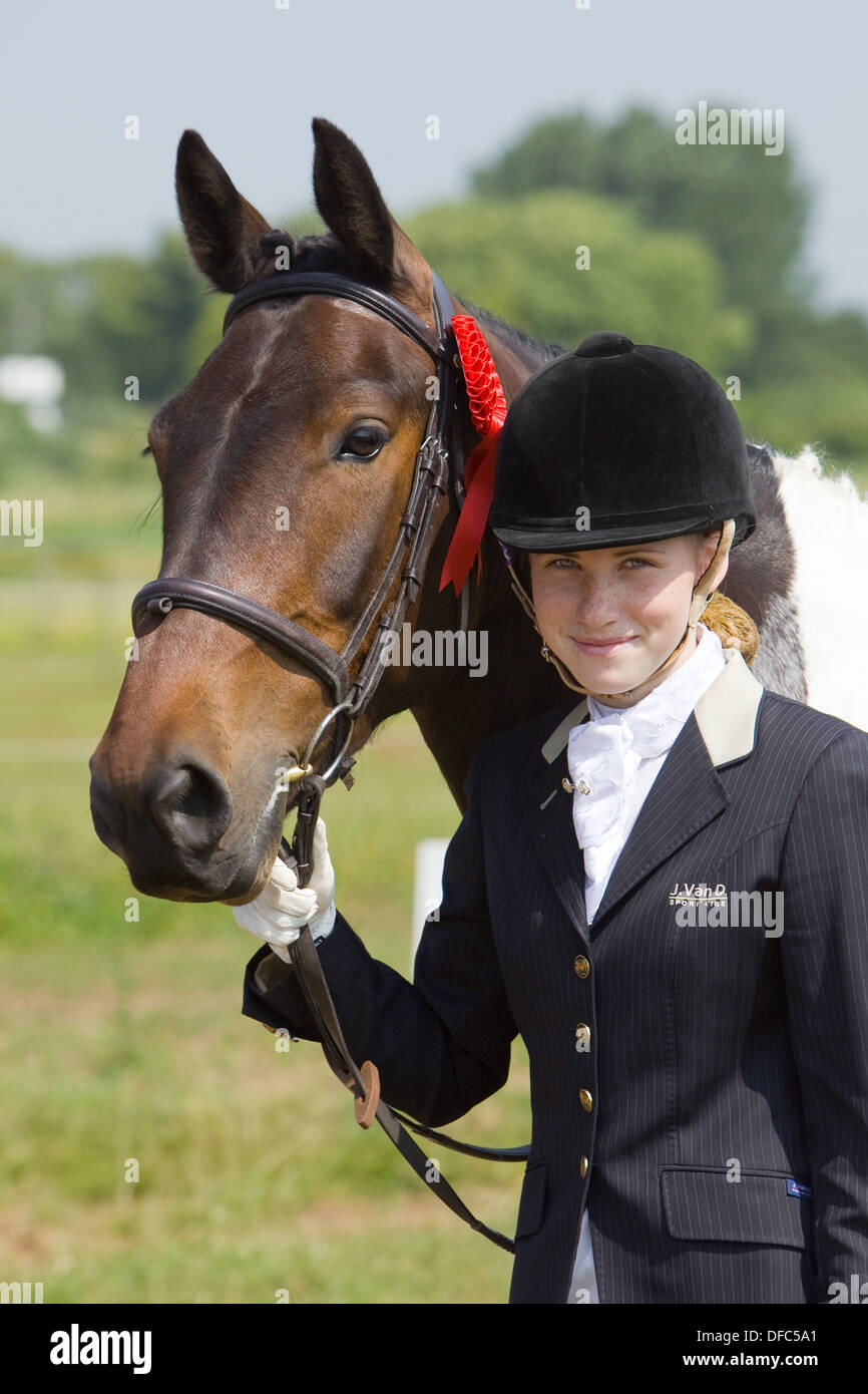 A competitor with their horse at an outdoor equestrian competition ...