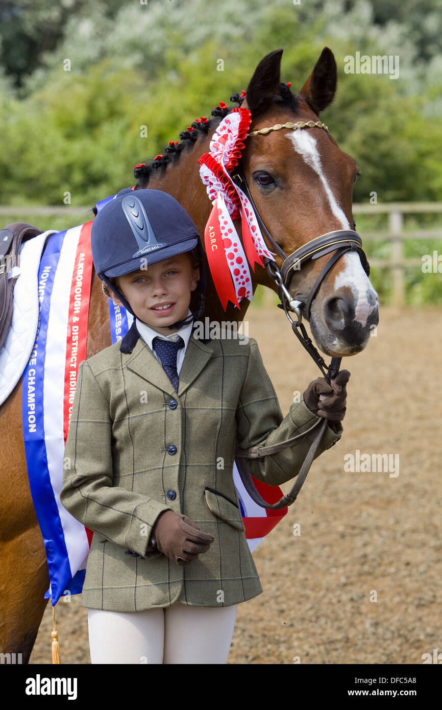 A competitor with their horse at an outdoor equestrian competition ...