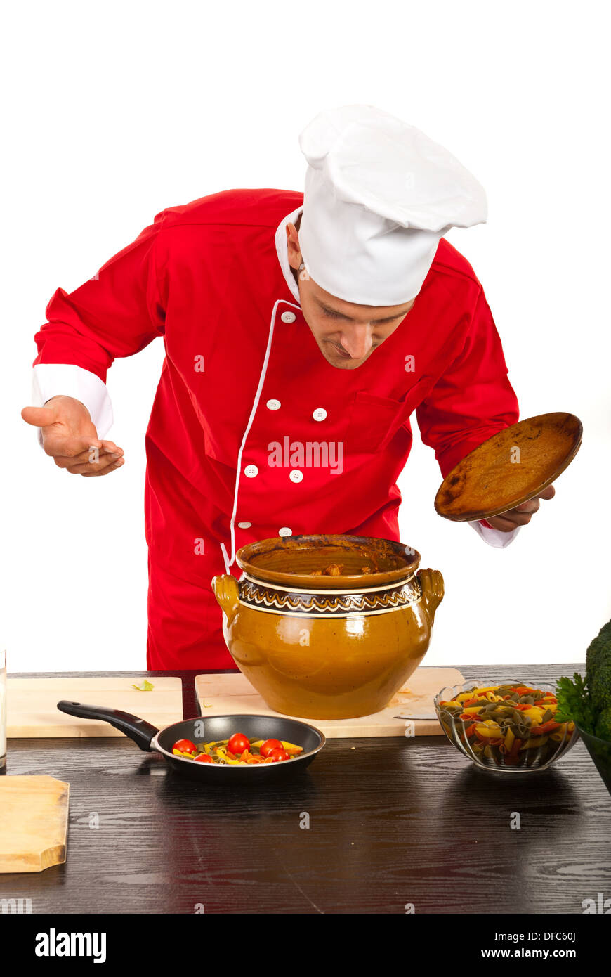 Chef smelling food against white background Stock Photo - Alamy