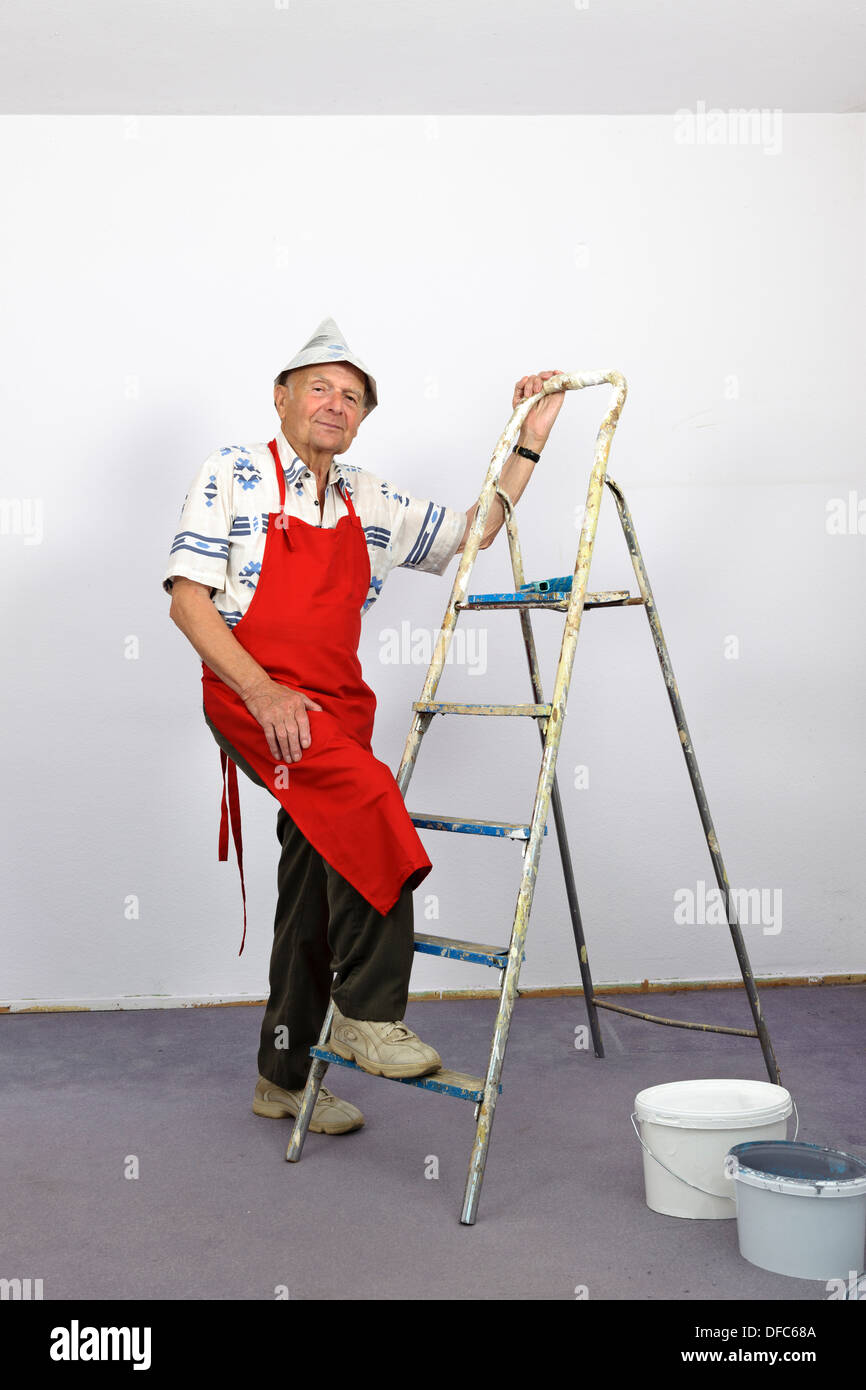 Germany, Portrait of senior man holding step ladder Stock Photo - Alamy