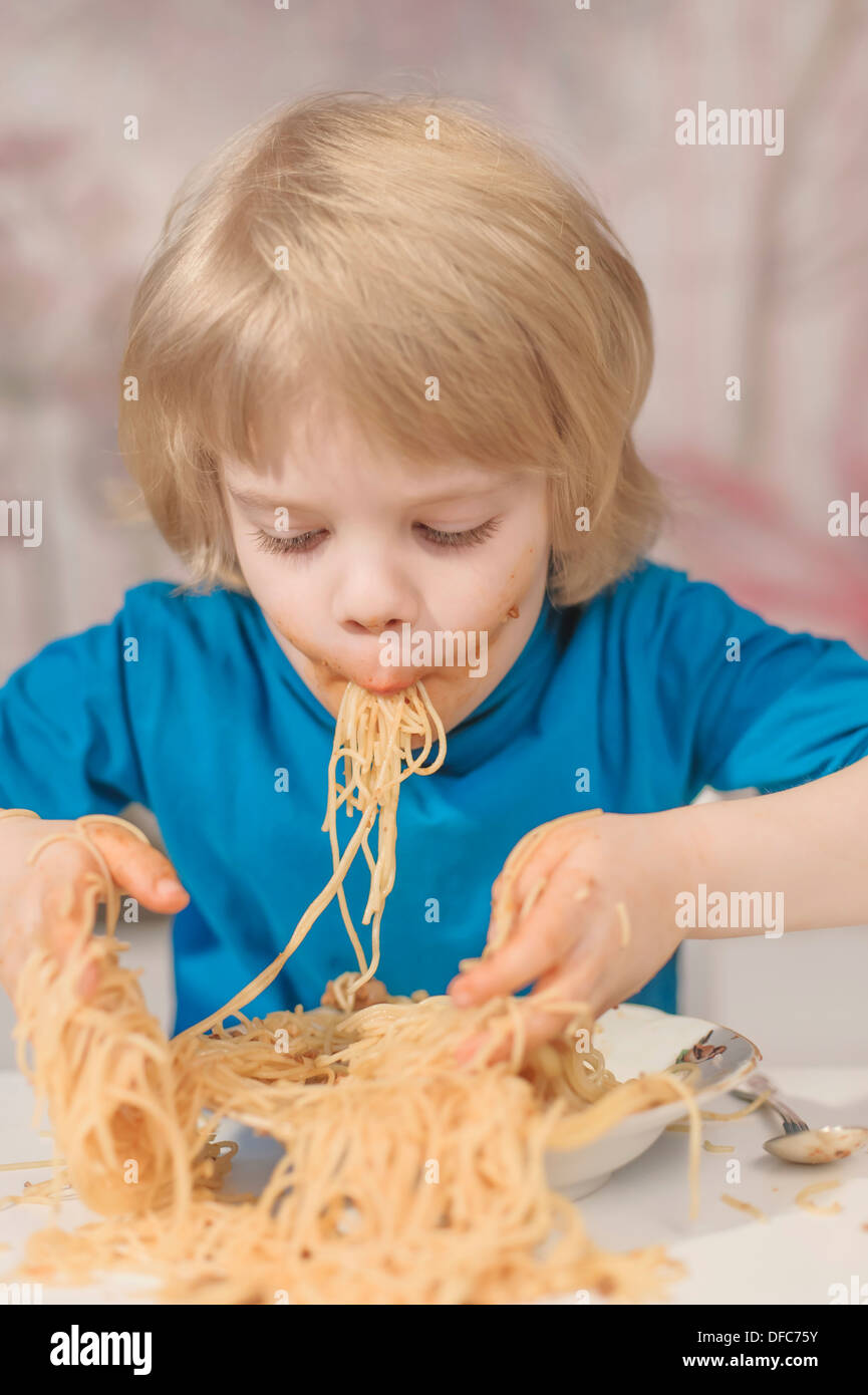 Boy eating messy spaghetti hi-res stock photography and images - Alamy