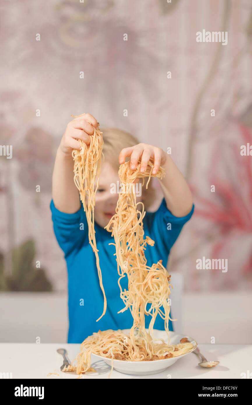 Child eating spaghetti with hands hi-res stock photography and images ...