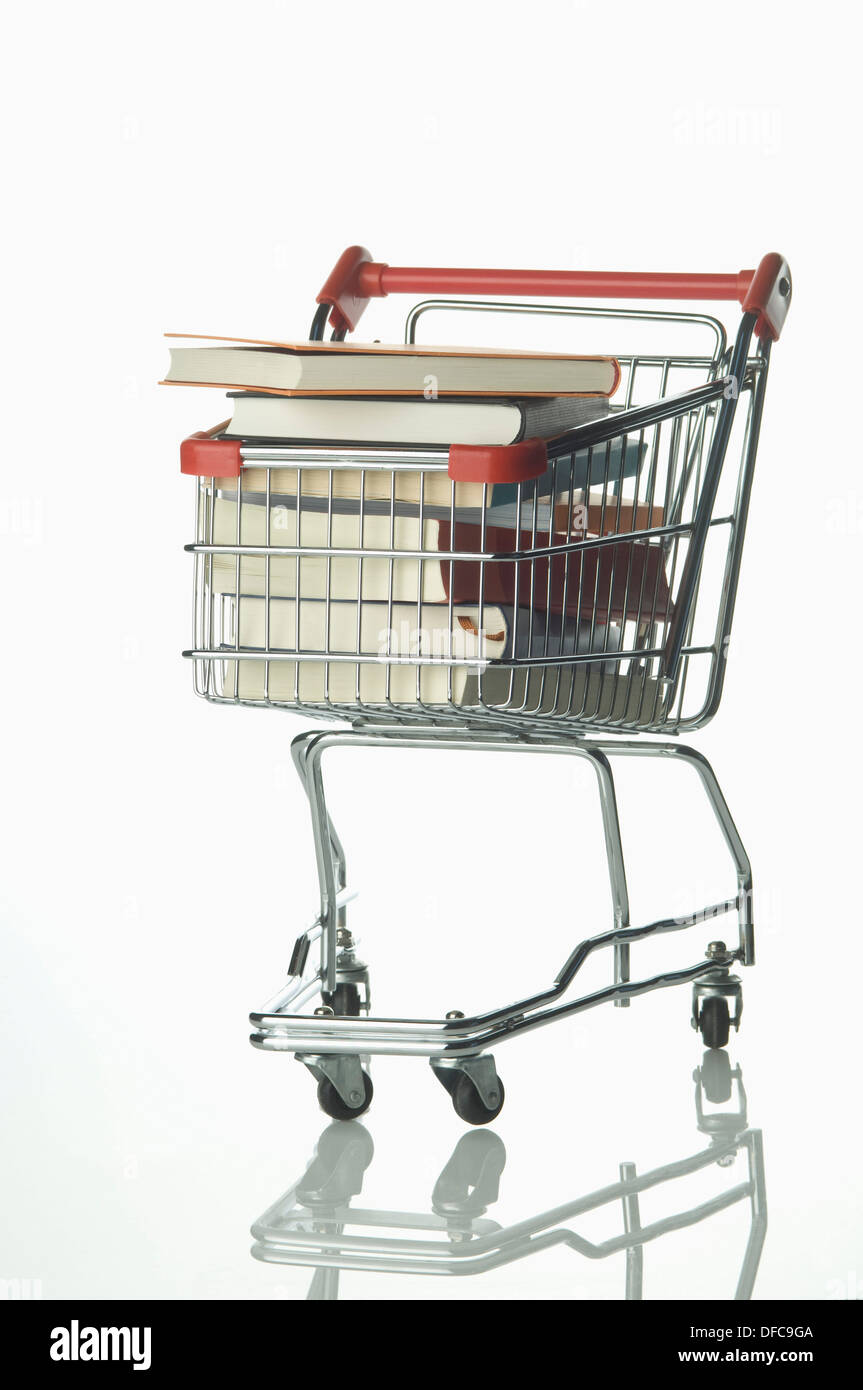Stack of books in shopping cart on white background, close up Stock ...