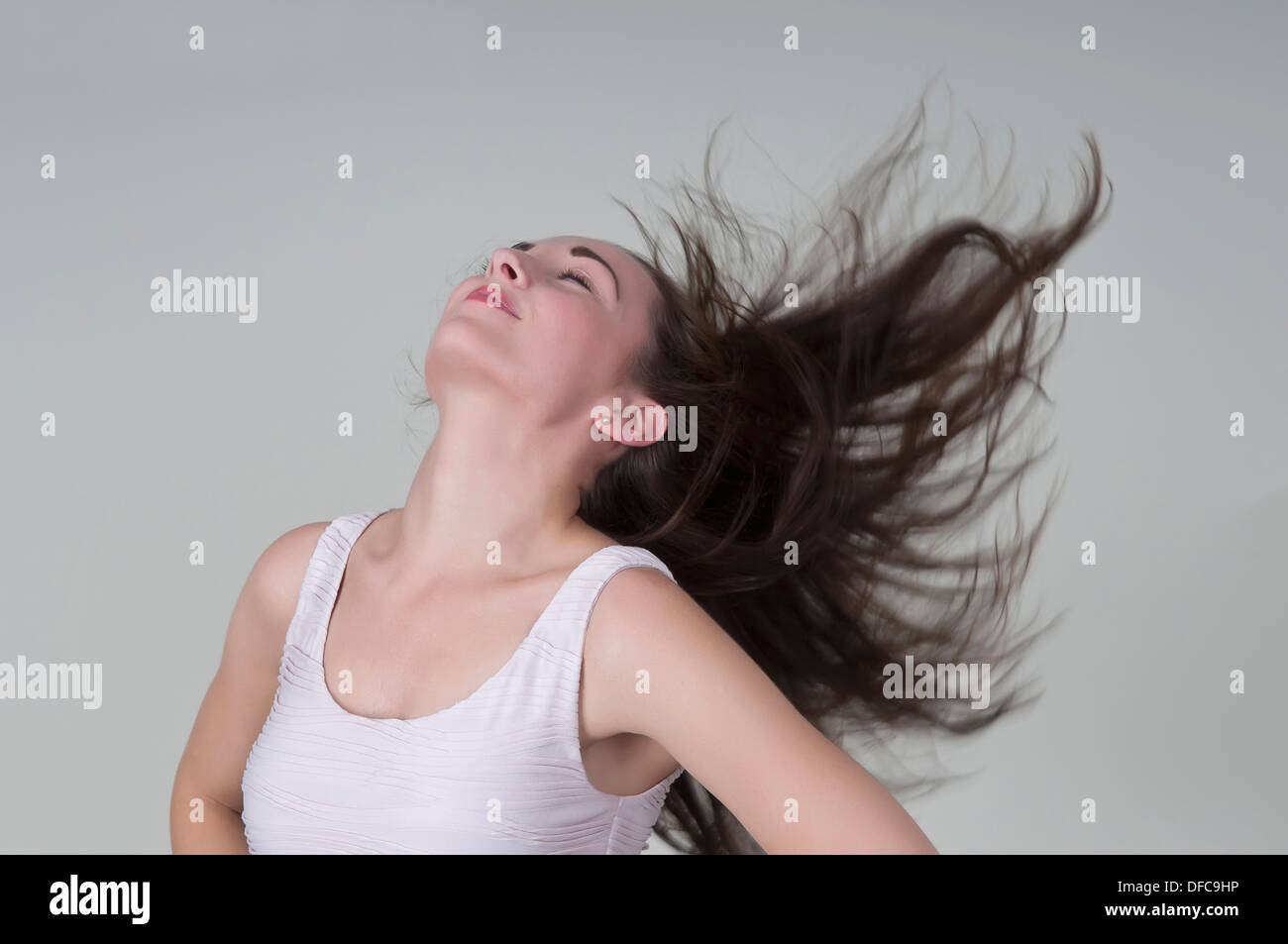 Young woman blowing hair Stock Photo - Alamy