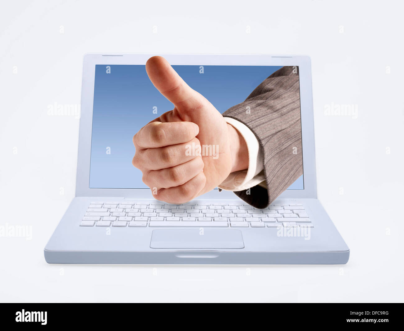 Manager hand giving thumbs up through lap top screen, digital composite ...