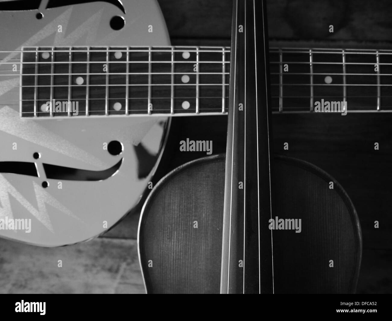 A resonating guitar and a violin/fiddle laying across each other Stock ...