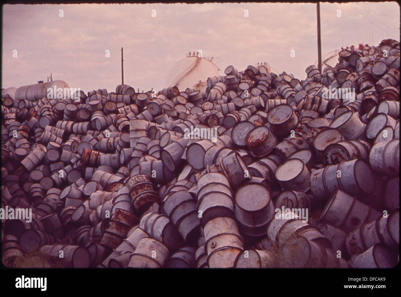 This photograph shows a large pile of damaged oil drums near the Exxon ...