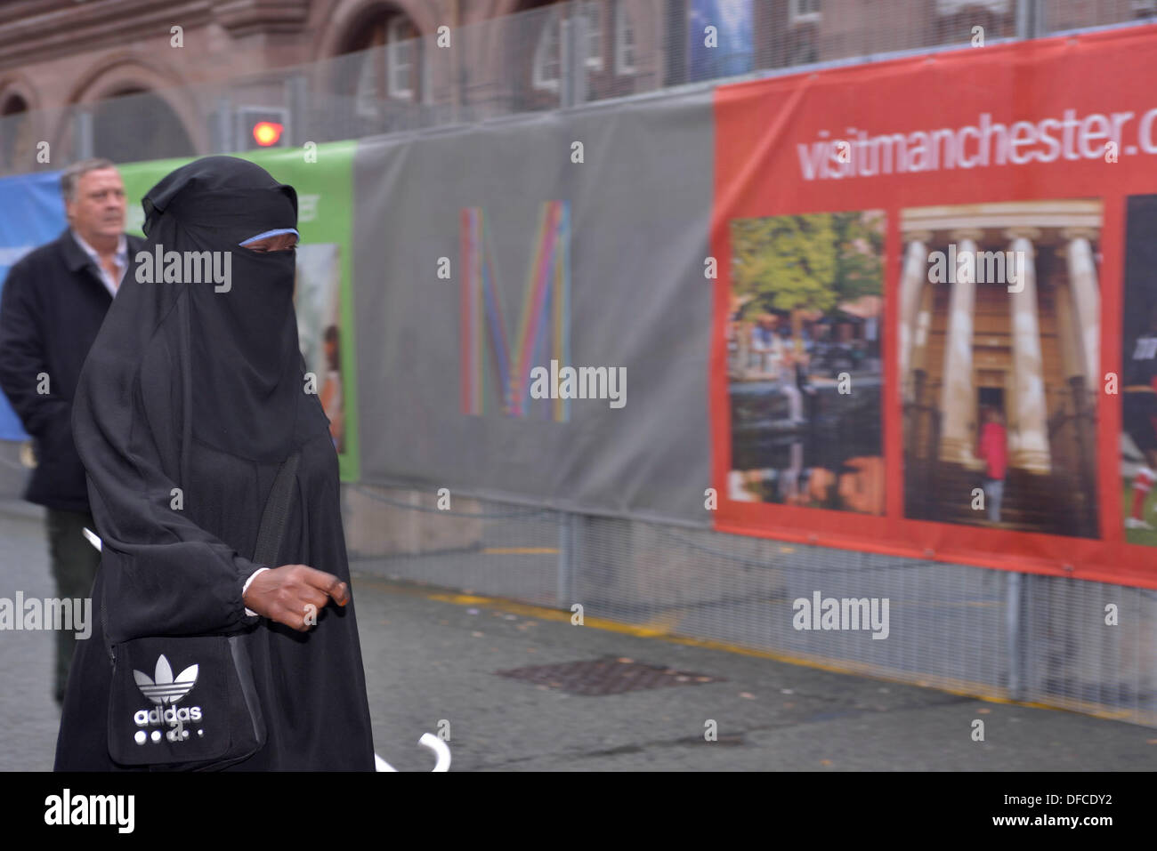 Manchester, UK. 2nd October 2013. A woman in a burka walks outside the ...