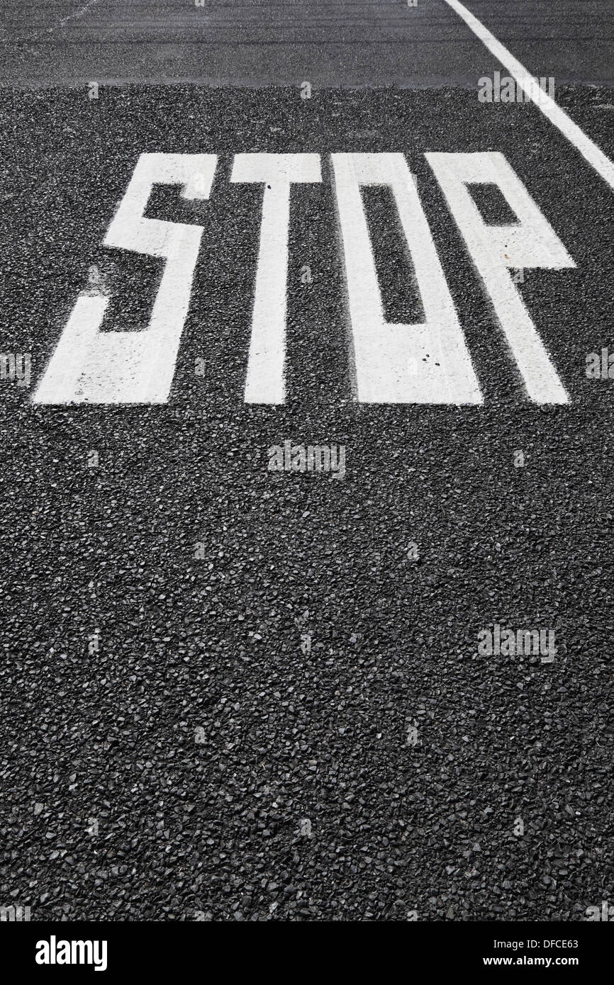 Stop road sign on paved road Stock Photo - Alamy