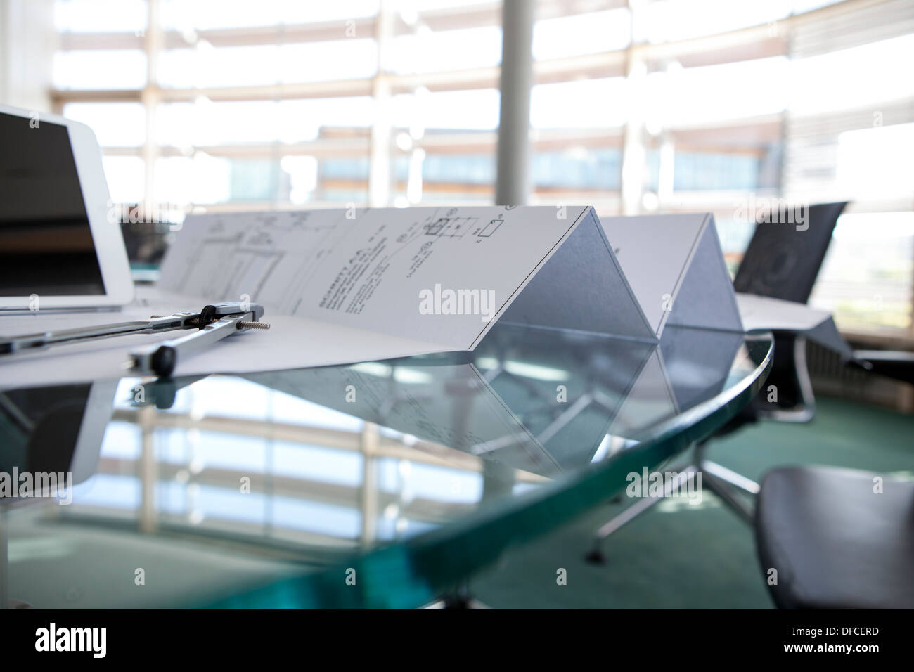 Architectural plan on conference room table Stock Photo - Alamy