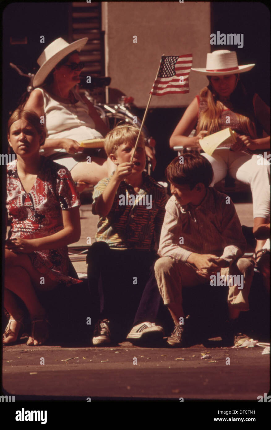 BOY WAVES FLAG AS CIRCUS PERFORMERS AND MARCHING UNITS PASS BY IN THE ...