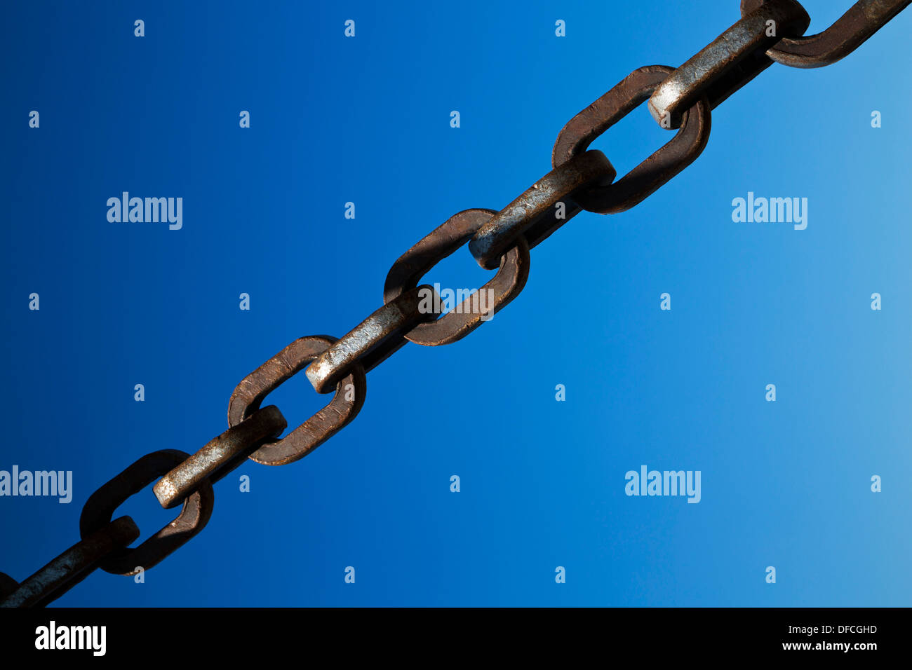 Chain against blue background, close up Stock Photo - Alamy