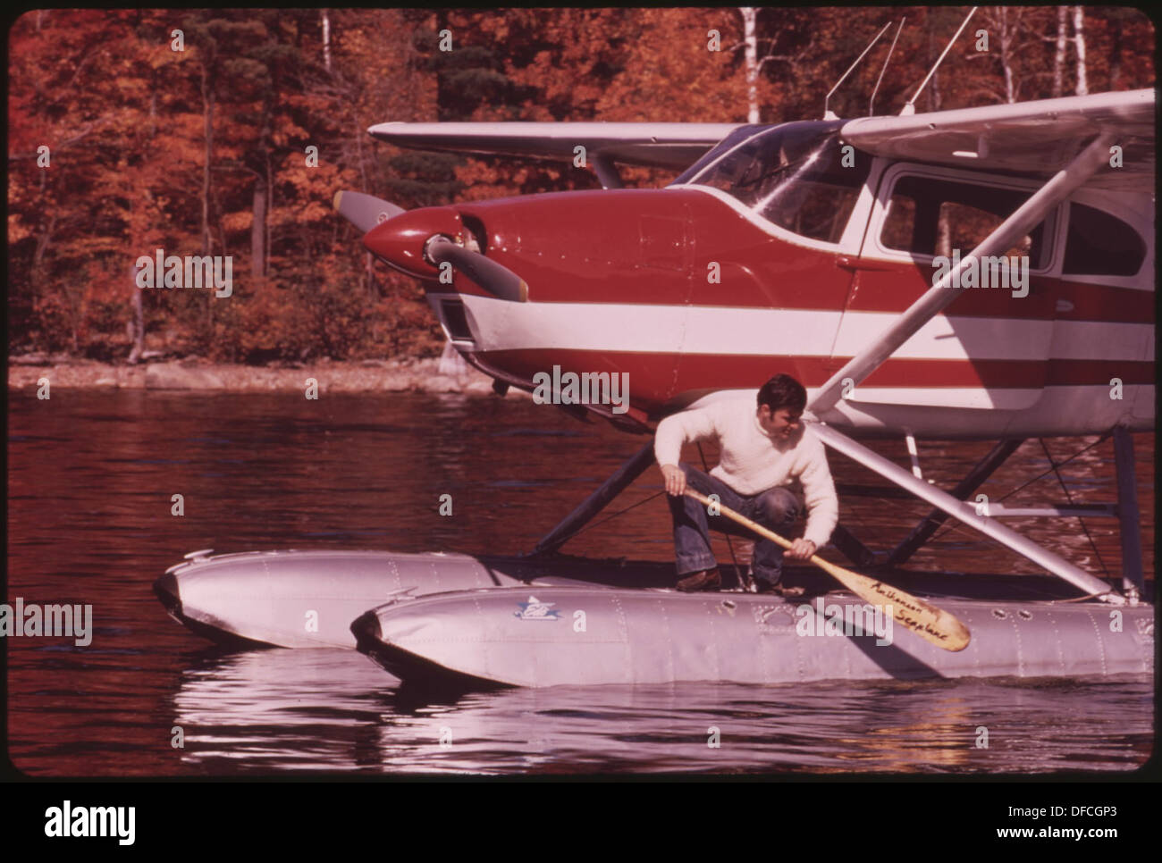 Bush pilot Ted Anthonsen stands by his 4-seater seaplane moored near ...