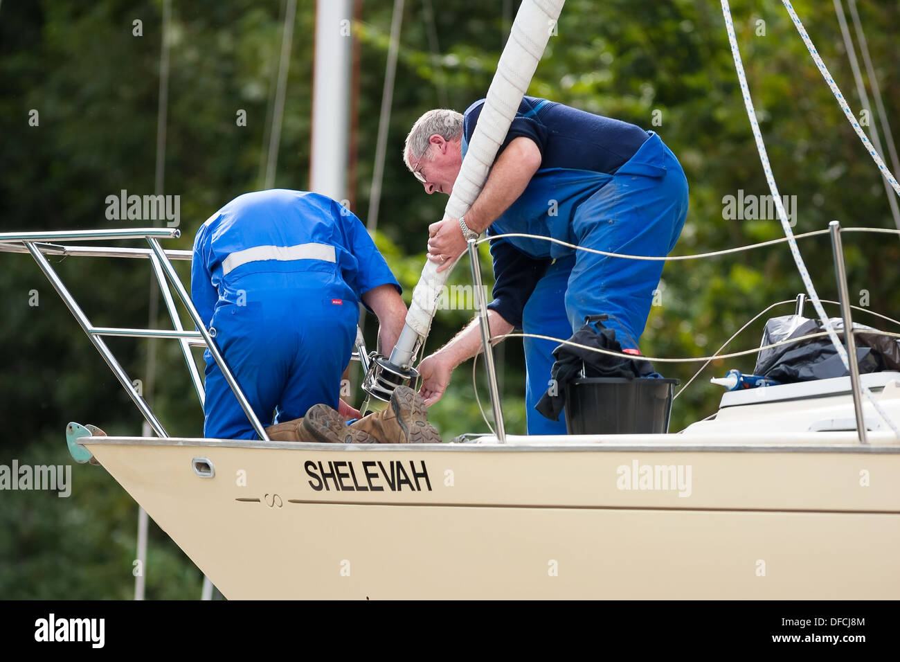 boatyard workmen fixing sail Stock Photo - Alamy
