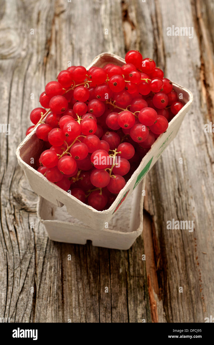 Cardboard box filled with red currants on table, close up Stock Photo ...