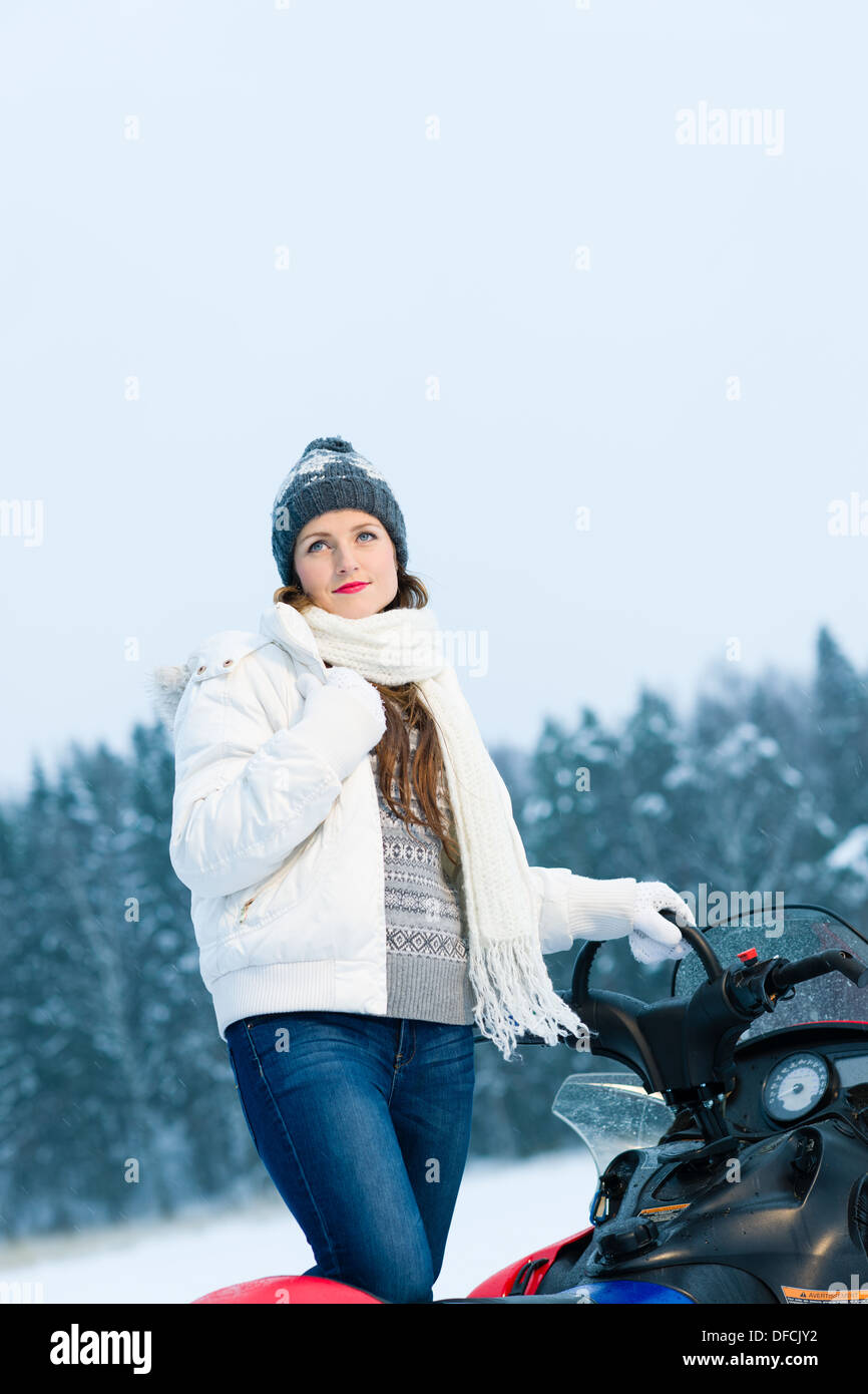 Winter, beautiful woman and a snowmobile, vertical format Stock Photo ...