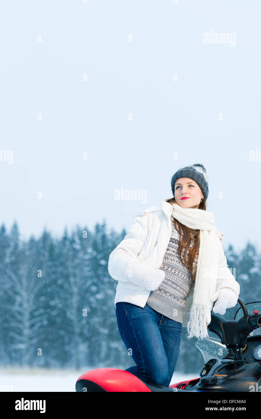 Winter, beautiful woman and a snowmobile, vertical format Stock Photo ...