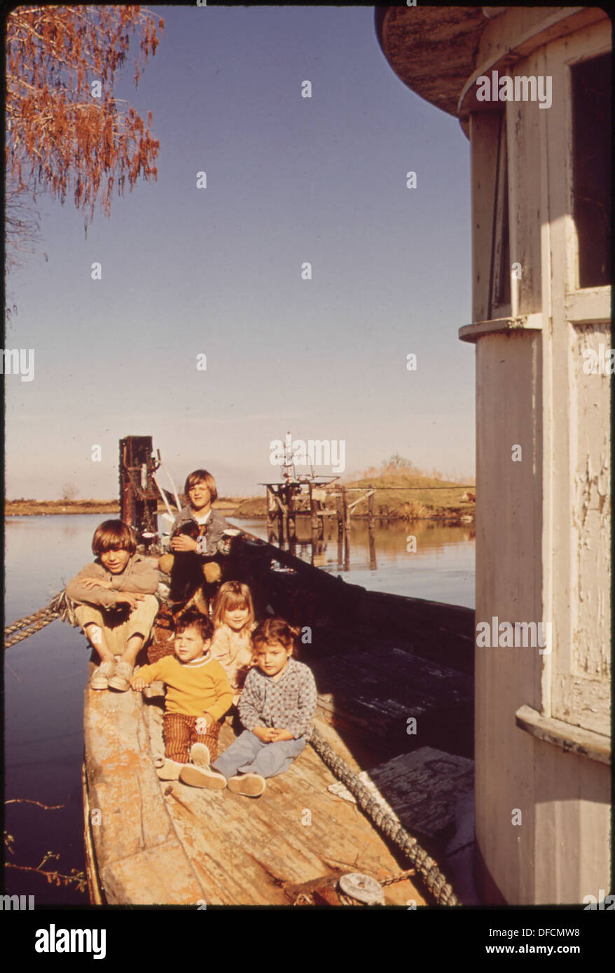 Children of fishermen are seen aboard an old fishing boat, with a gas ...