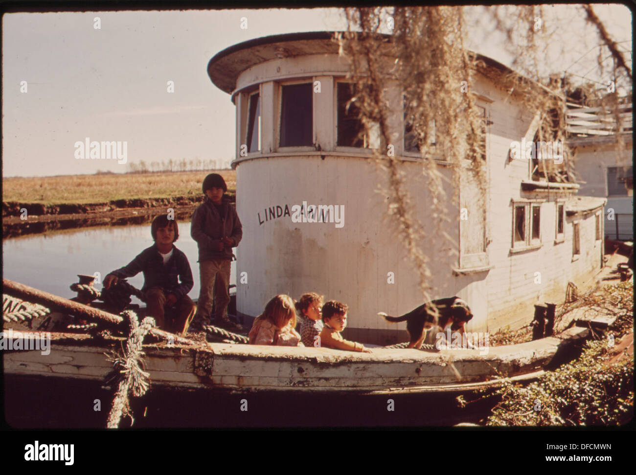 CHILDREN OF FISHERMEN PLAY ON SELDOM-USED BOAT 545957 Stock Photo - Alamy