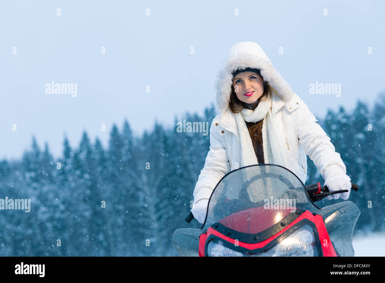 Winter, beautiful woman and a snowmobile, horizon format Stock Photo ...