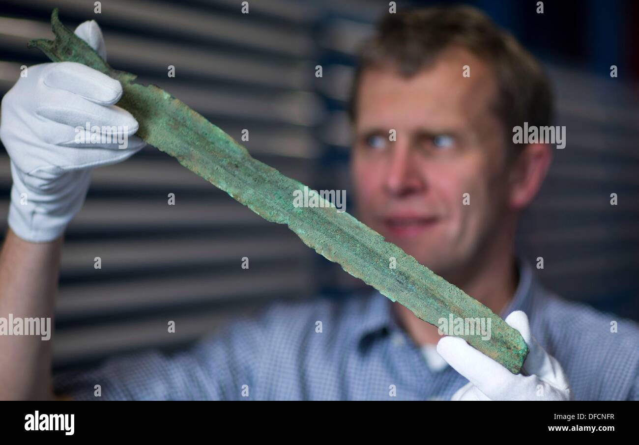 Archaeologist Jens-Peter Schmidt shows a more than 3,000 year old sword in the depot of the ...