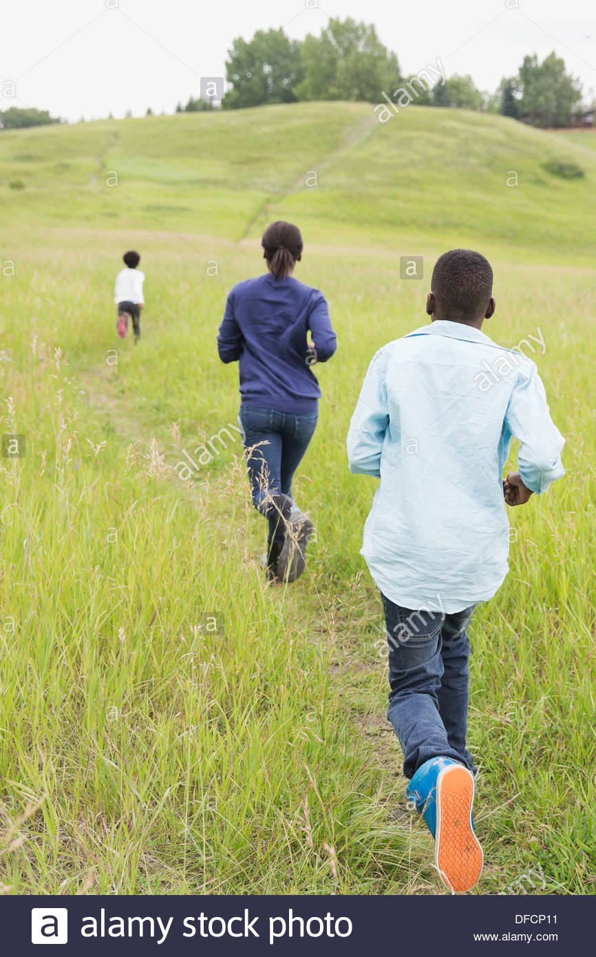 Boys running through the field hi-res stock photography and images - Alamy
