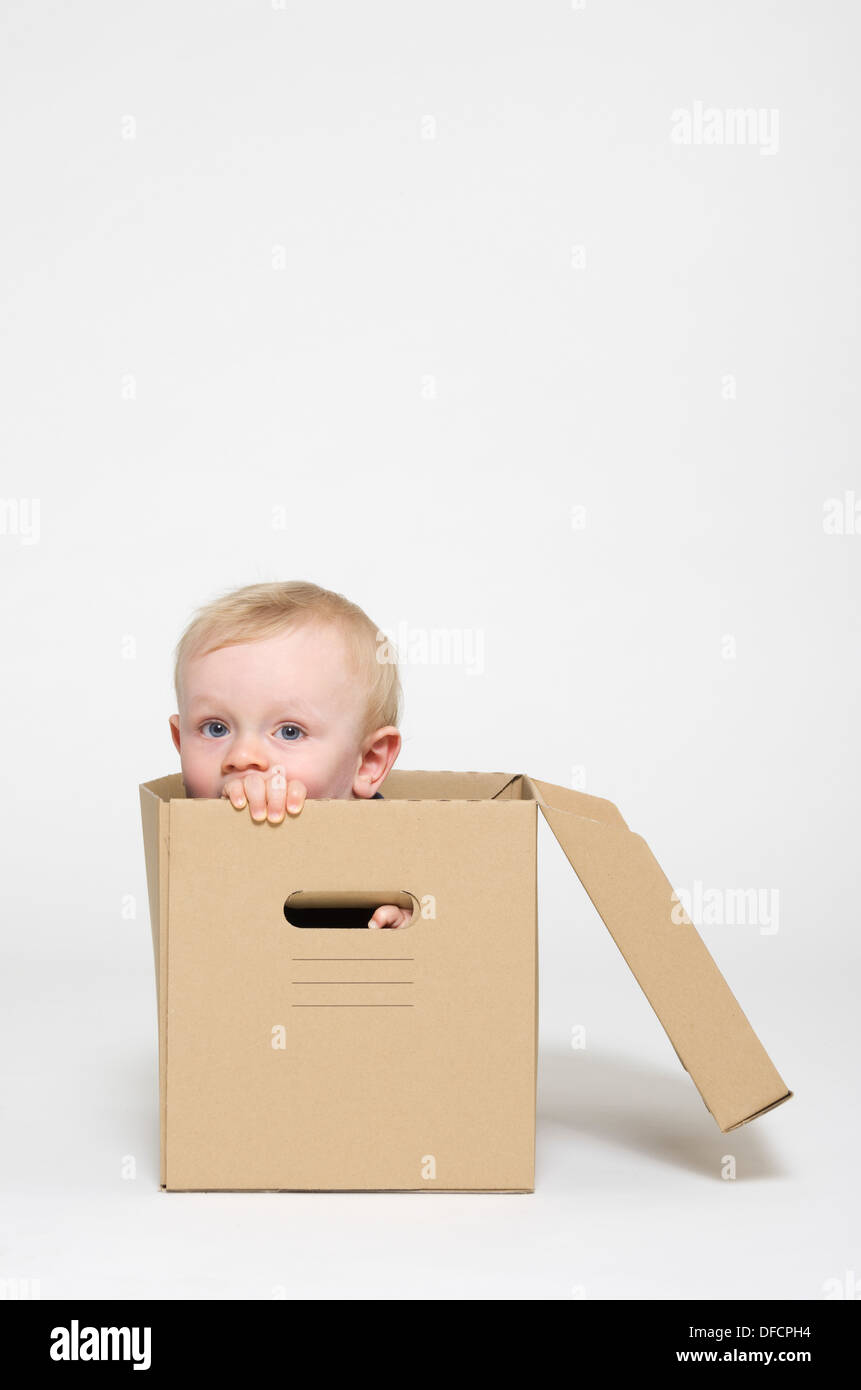 Portrait of baby boy sitting in box on white background Stock Photo - Alamy