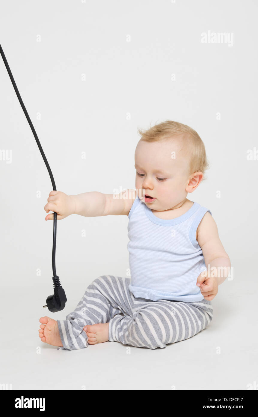 Boy playing with cable wire Stock Photo - Alamy